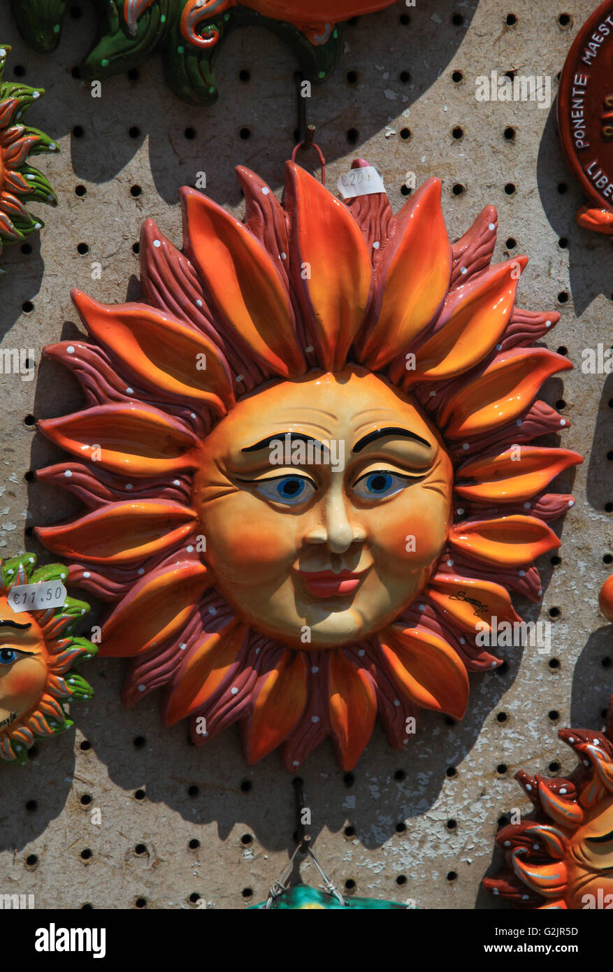 Italian sun face pottery Majolica style in shop window orange red ...