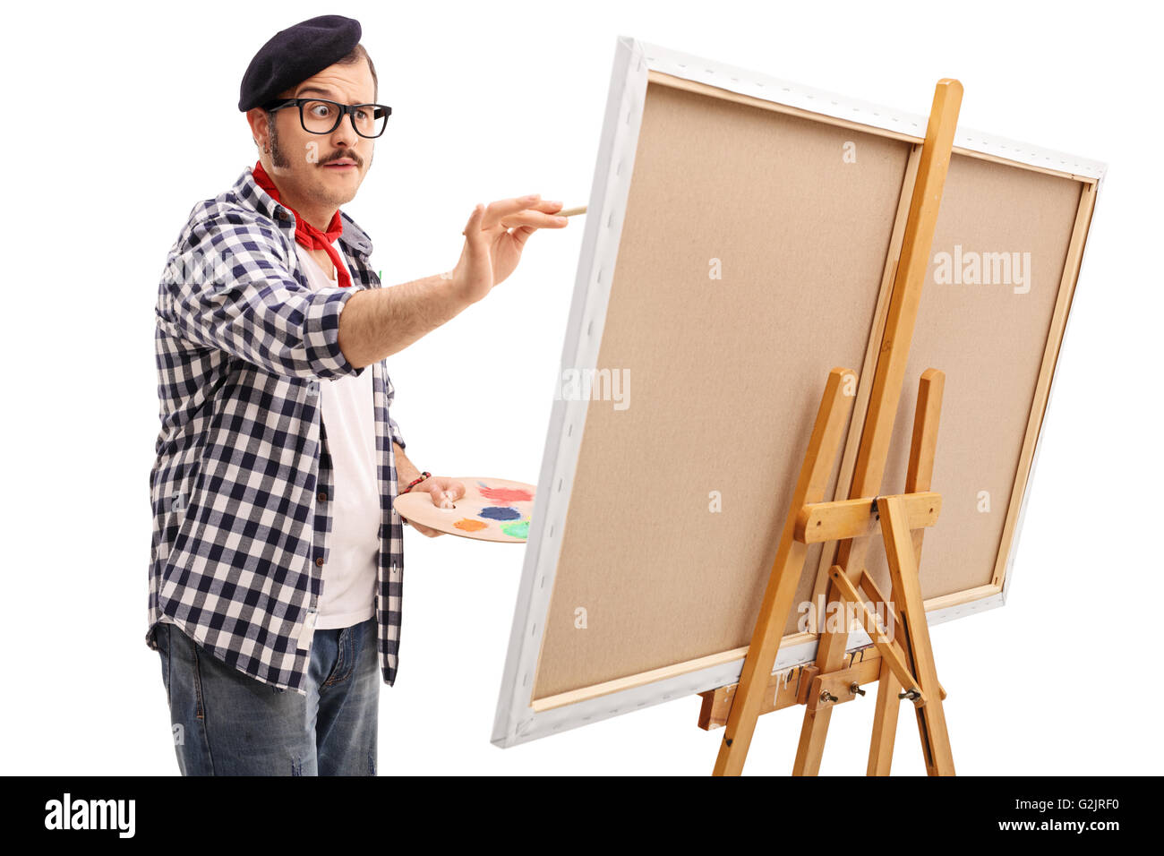 Young focused artist painting on a canvas isolated on white background ...