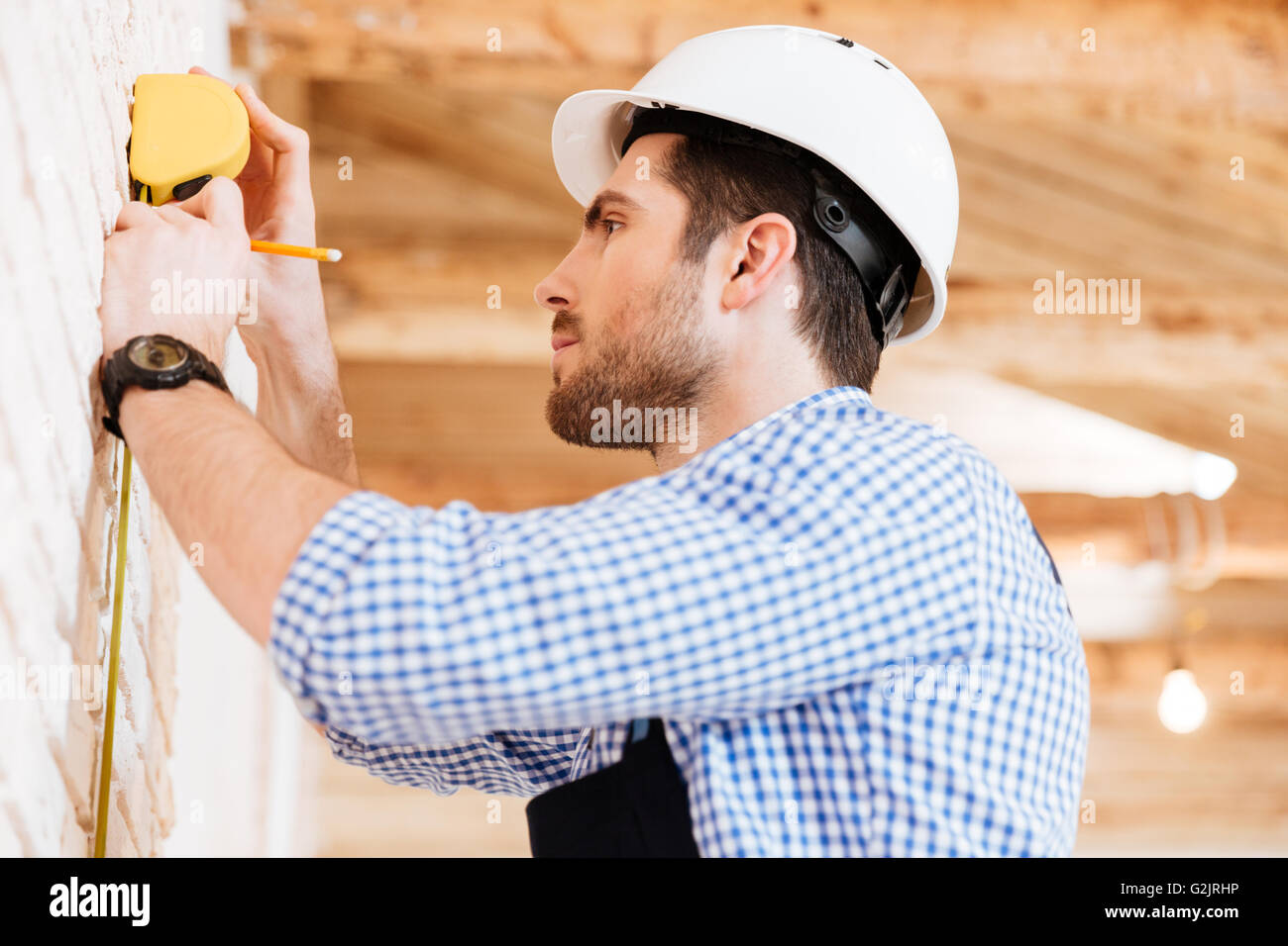 Concentrated construction worker making a layout in a new house Stock ...