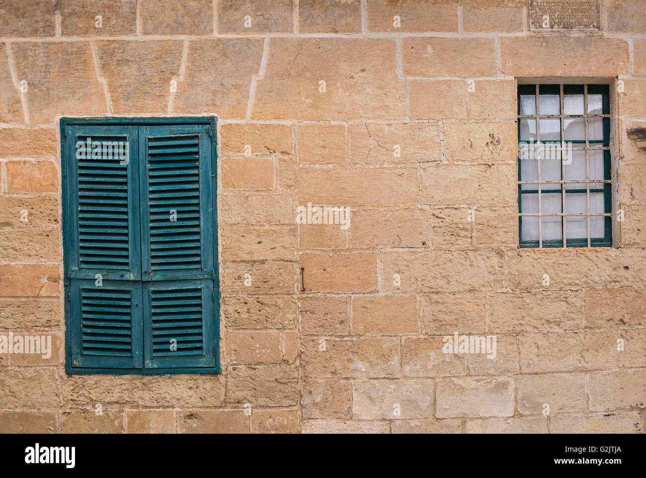 Two windows on the stone wall of an old house in the former capital of ...