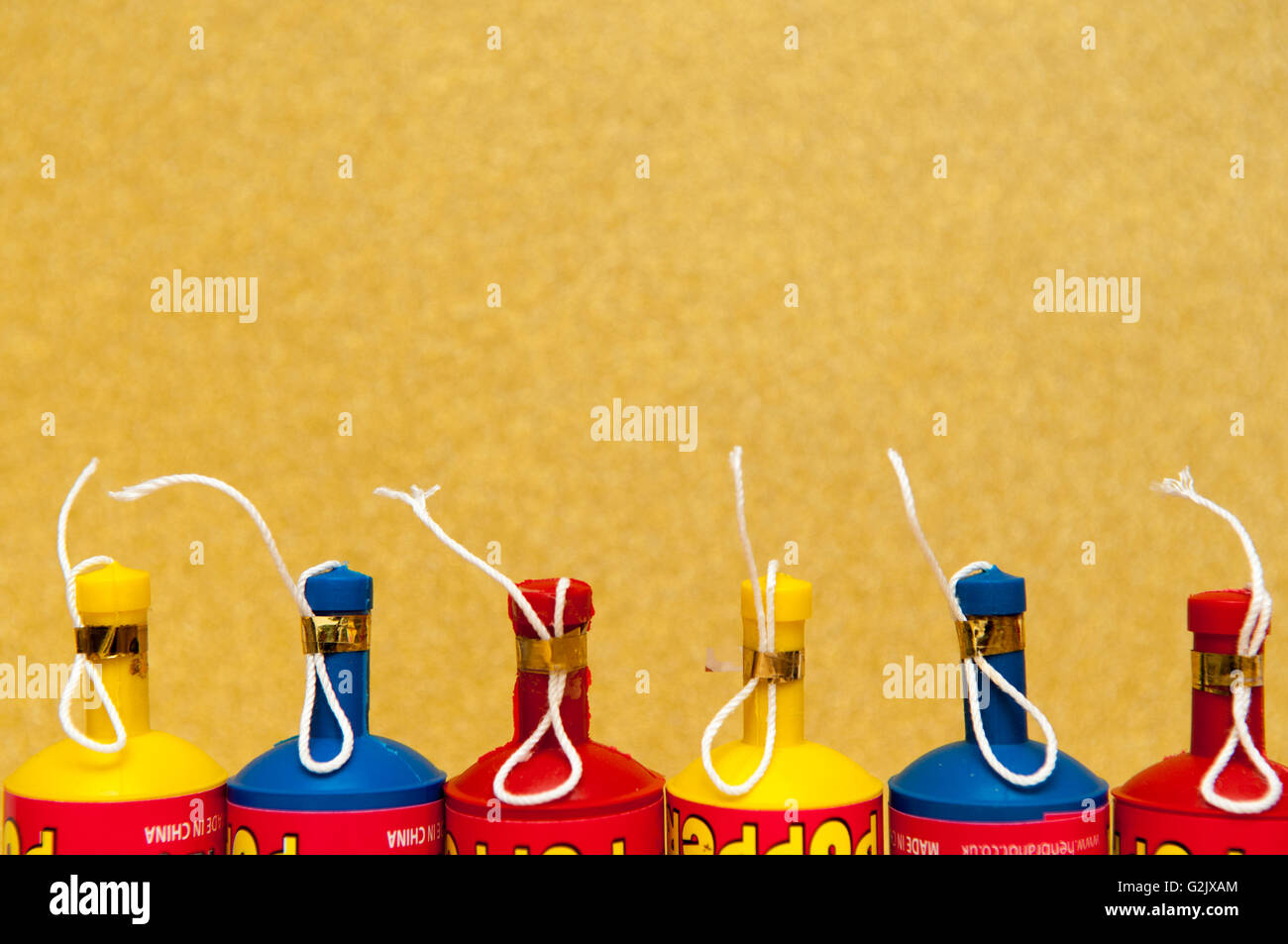 Colorful party poppers arranged in a row on a bright background Stock ...