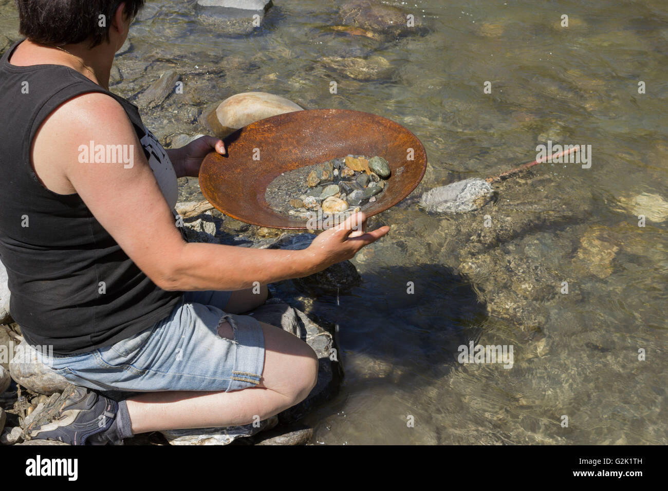 woman Panning for Alluvial Gold, using the traditional panning method ...