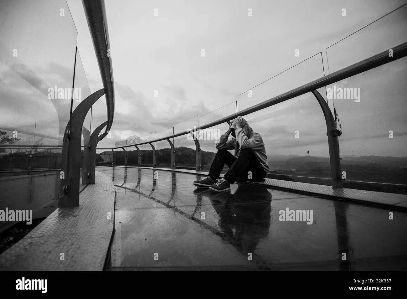 Sadness man depressed sitting alone in the mountains Stock Photo - Alamy