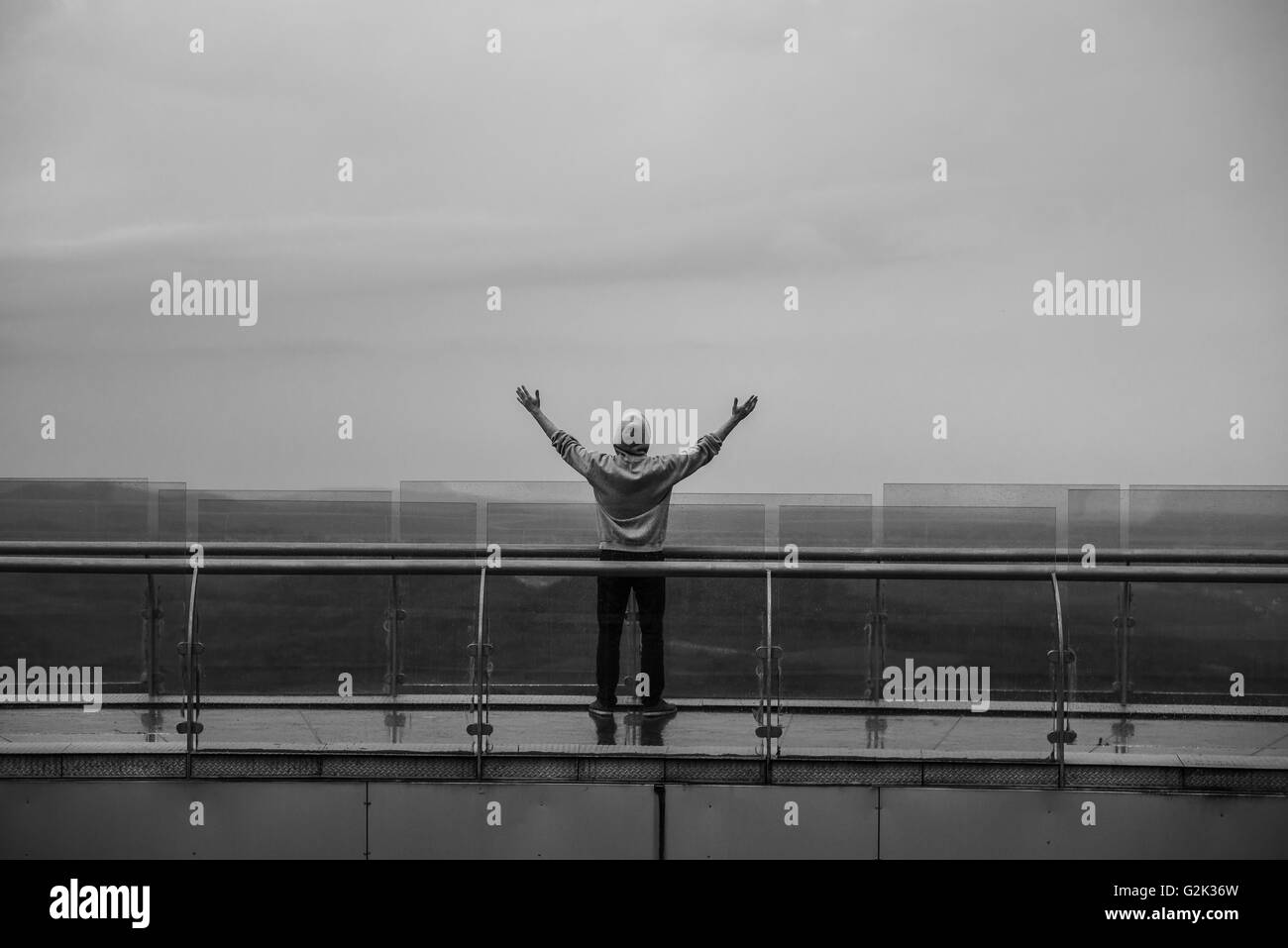 Happy man with hands up standing in the mountains Stock Photo - Alamy
