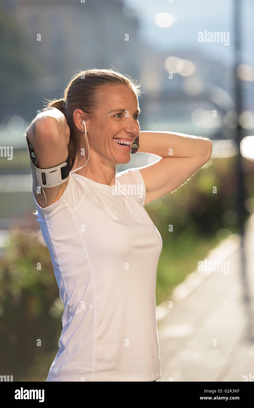 portrait of jogging woman before running on early morning with sunrise ...