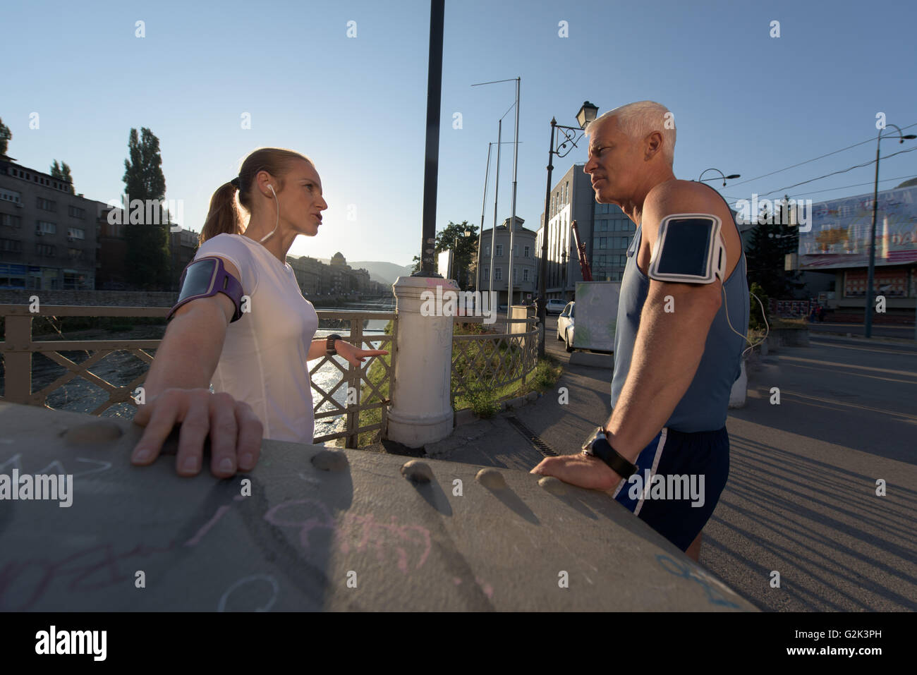 jogging couple check music playlist on phone and plan route before ...