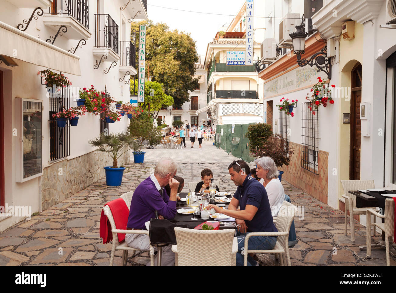People eating a meal outside at a restaurant, Estepona Old Town, Costa ...