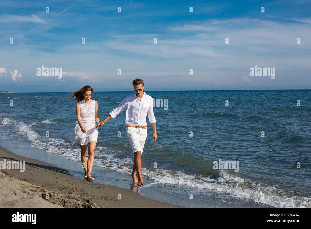 happy couple in love walking on the beach Stock Photo - Alamy