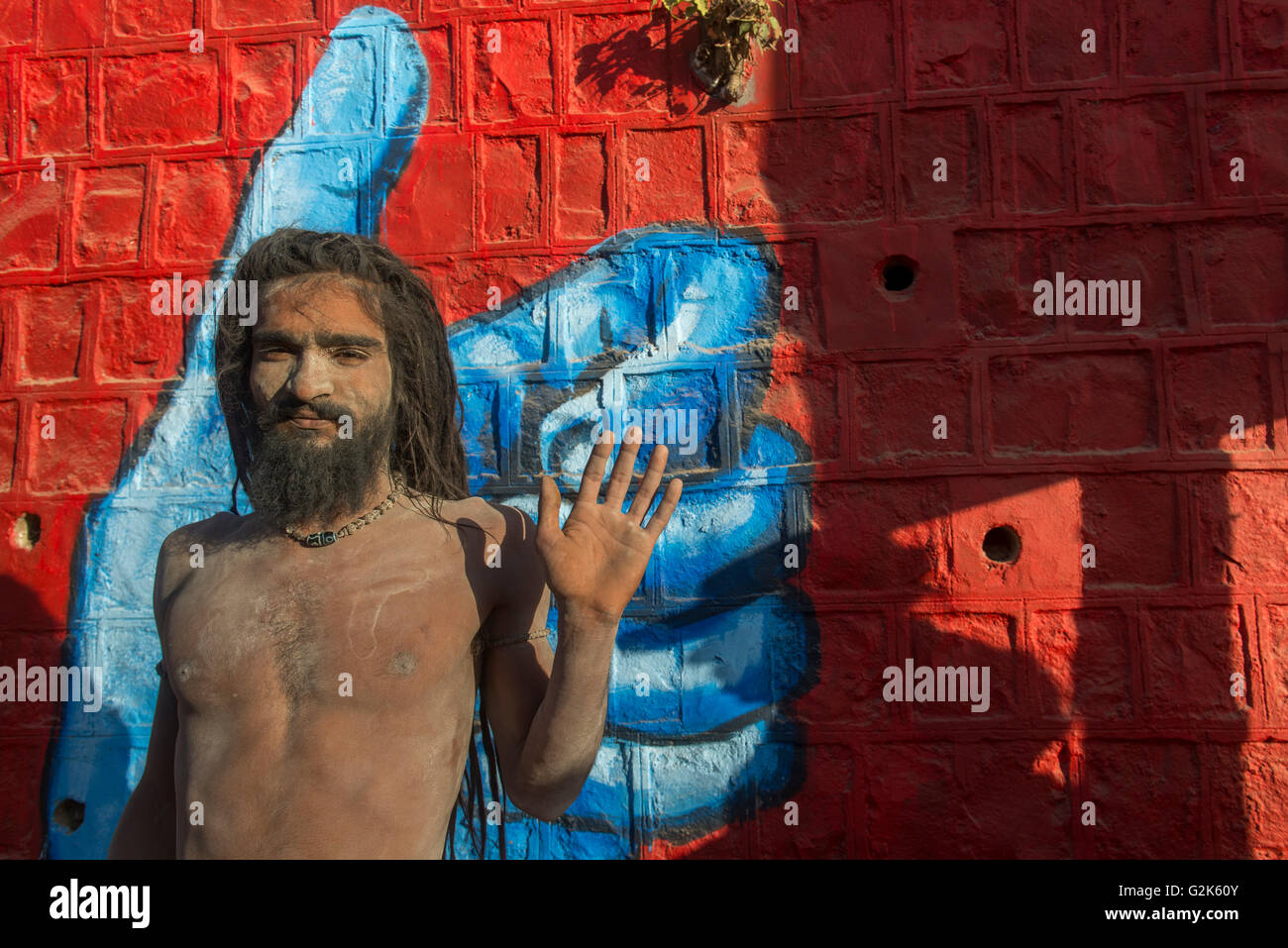 Naga Sadhu In Front Of Blue Hand Painted On Red Brick Wall At Shipra ...