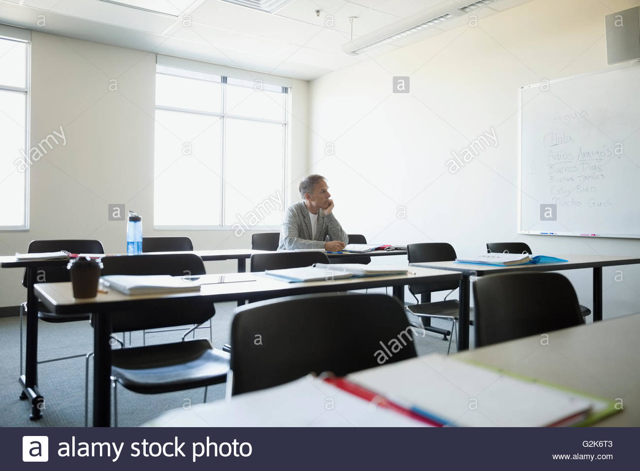Adult education student looking at whiteboard in classroom Stock Photo ...