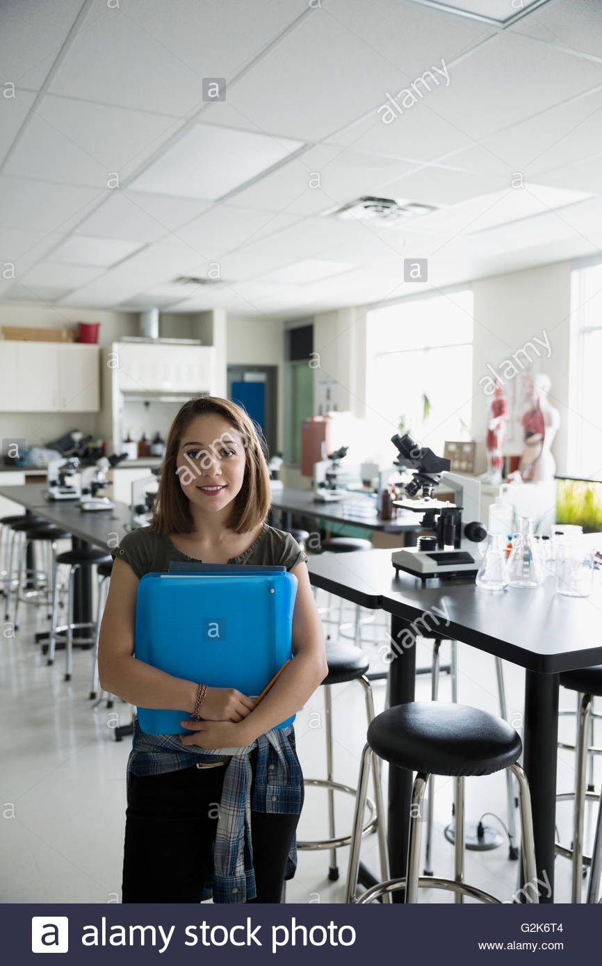 Portrait smiling college student with binder in science laboratory ...