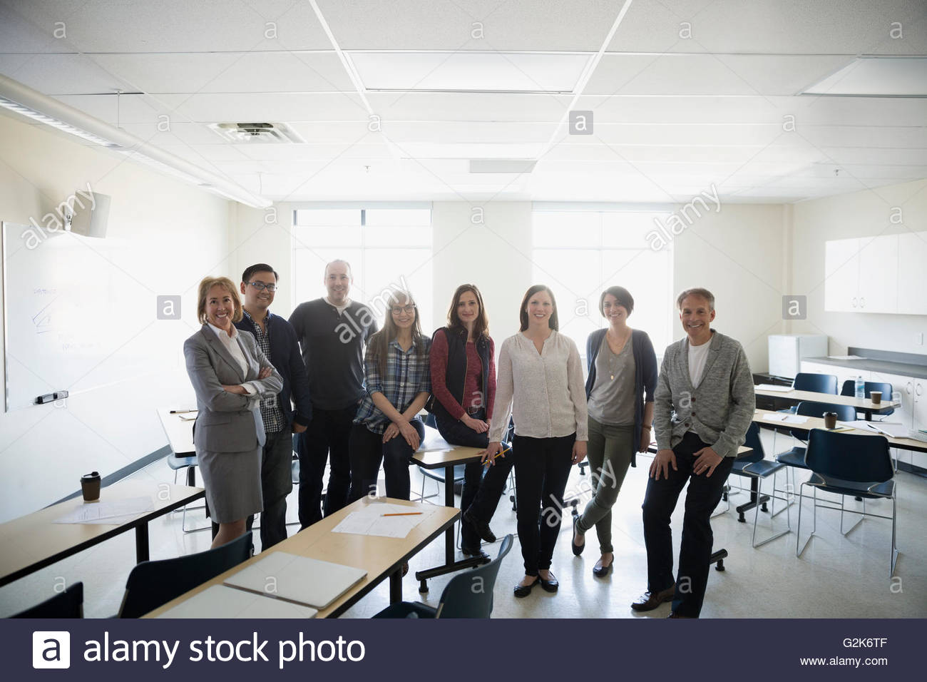 Portrait smiling adult education students in classroom Stock Photo - Alamy