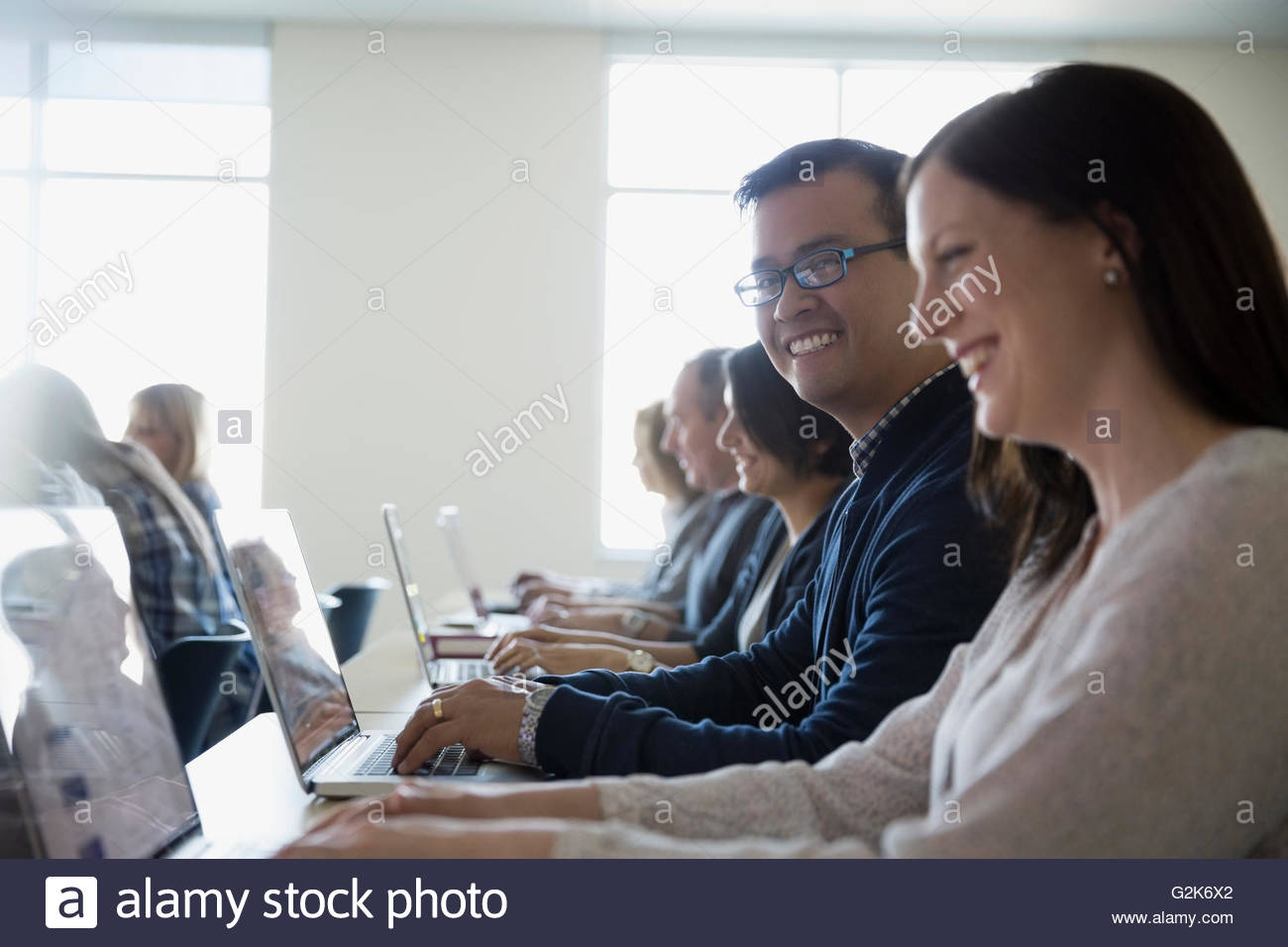 Happy students in classroom using hi-res stock photography and images ...