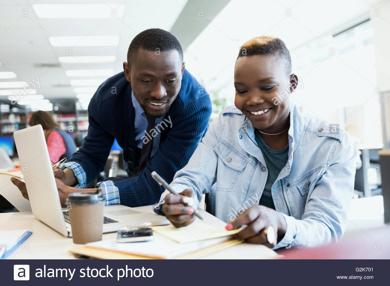 Students writing together in library hi-res stock photography and ...
