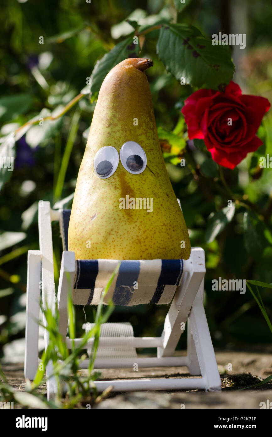 Funny pear with eyes in the sun Stock Photo - Alamy