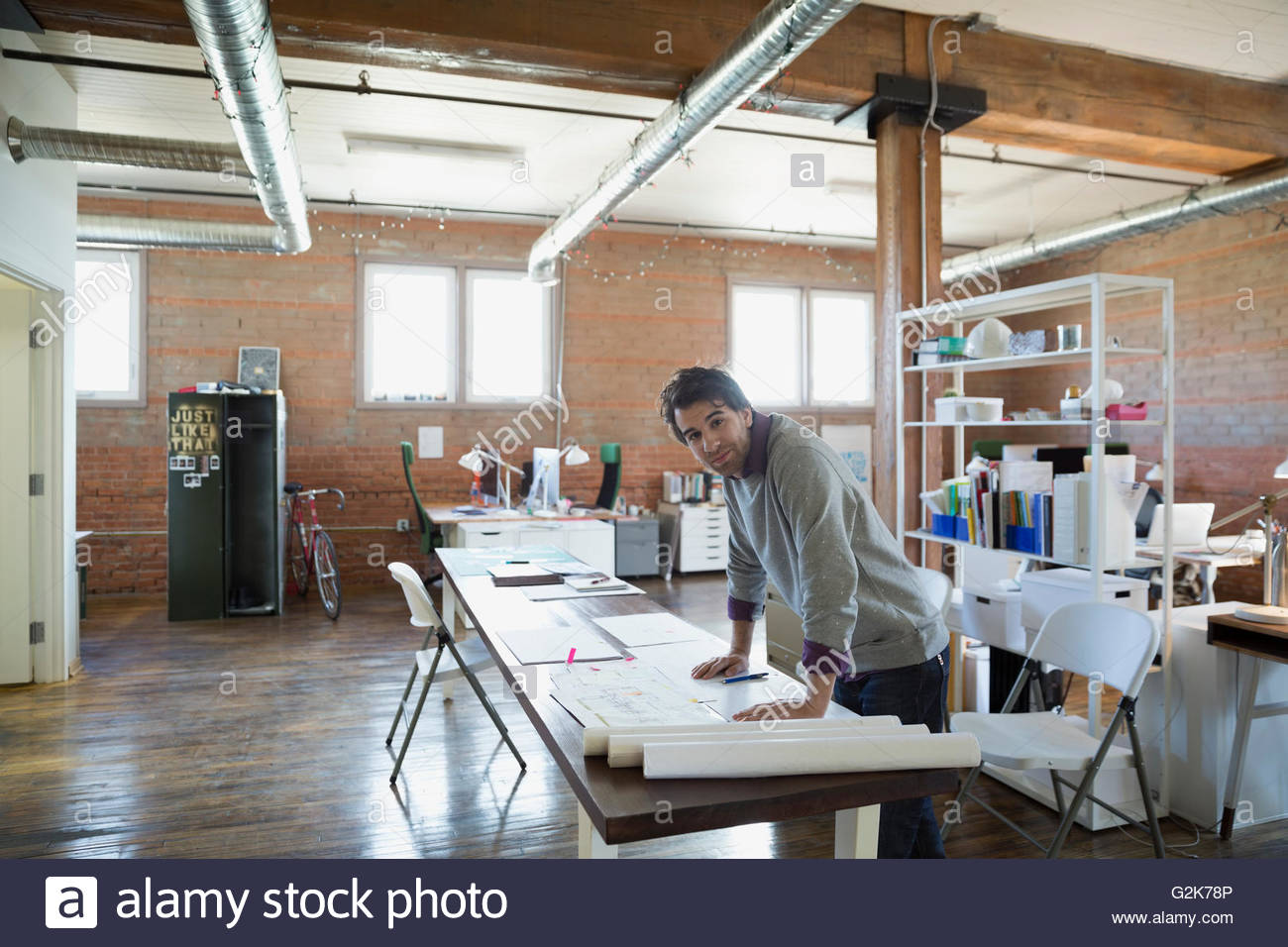 Portrait confident designer reviewing plans in office Stock Photo - Alamy