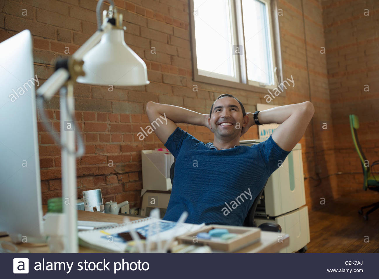 Person sitting behind desk hi-res stock photography and images - Alamy
