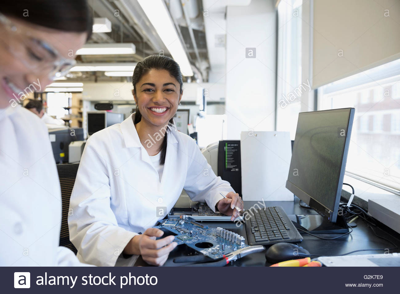 Portrait smiling engineer assembling electronics Stock Photo - Alamy