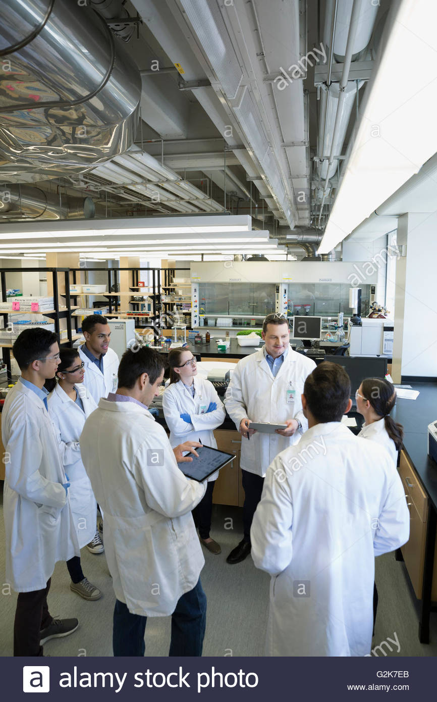 Scientists with digital tablet meeting in laboratory Stock Photo - Alamy