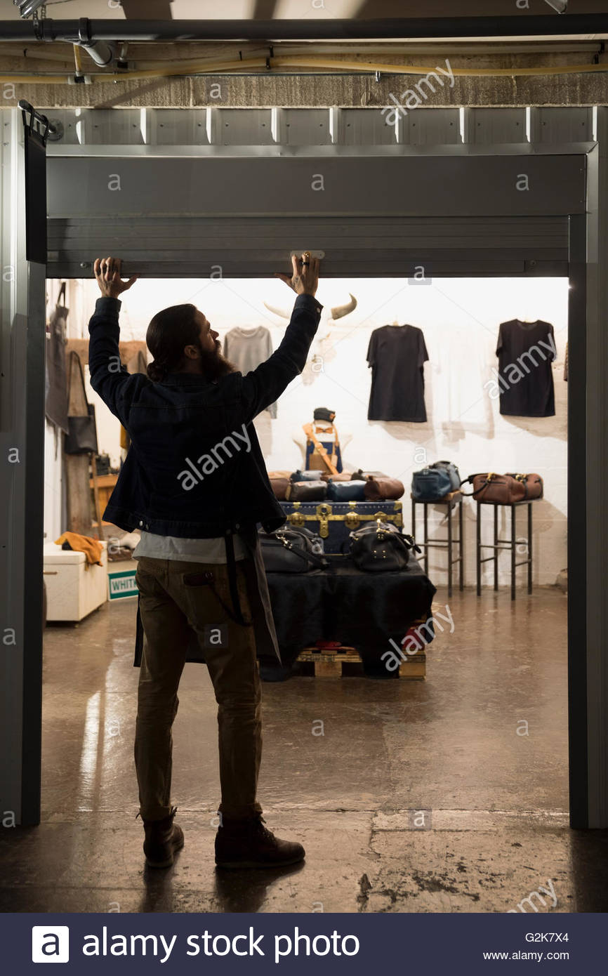 Leather shop owner entrepreneur opening shop gate Stock Photo - Alamy
