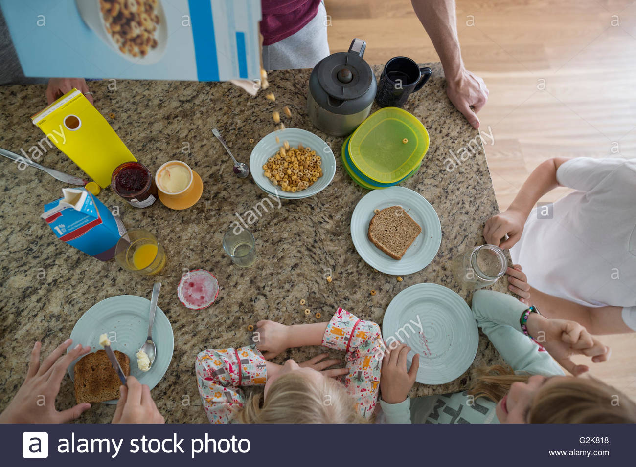 Family eating breakfast in kitchen Stock Photo - Alamy