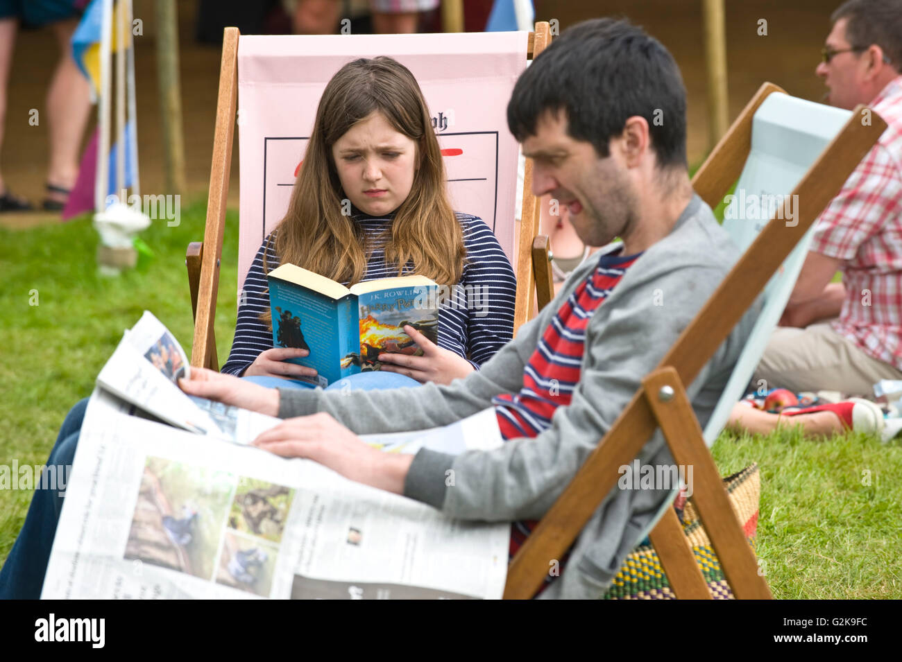 Visitors reading books on the lawn at Hay Festival 2016 Stock Photo - Alamy