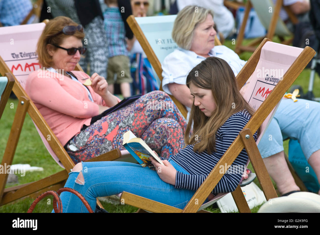 Visitors reading books on the lawn at Hay Festival 2016 Stock Photo - Alamy