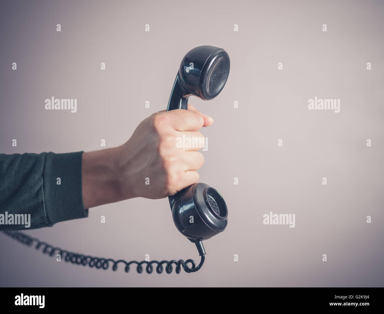 Hand holding old phone receiver hi-res stock photography and images - Alamy