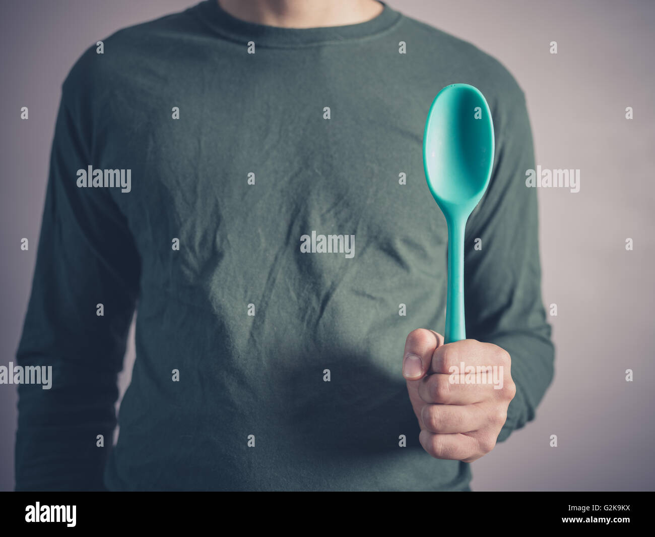 Man holding a spoon hi-res stock photography and images - Alamy