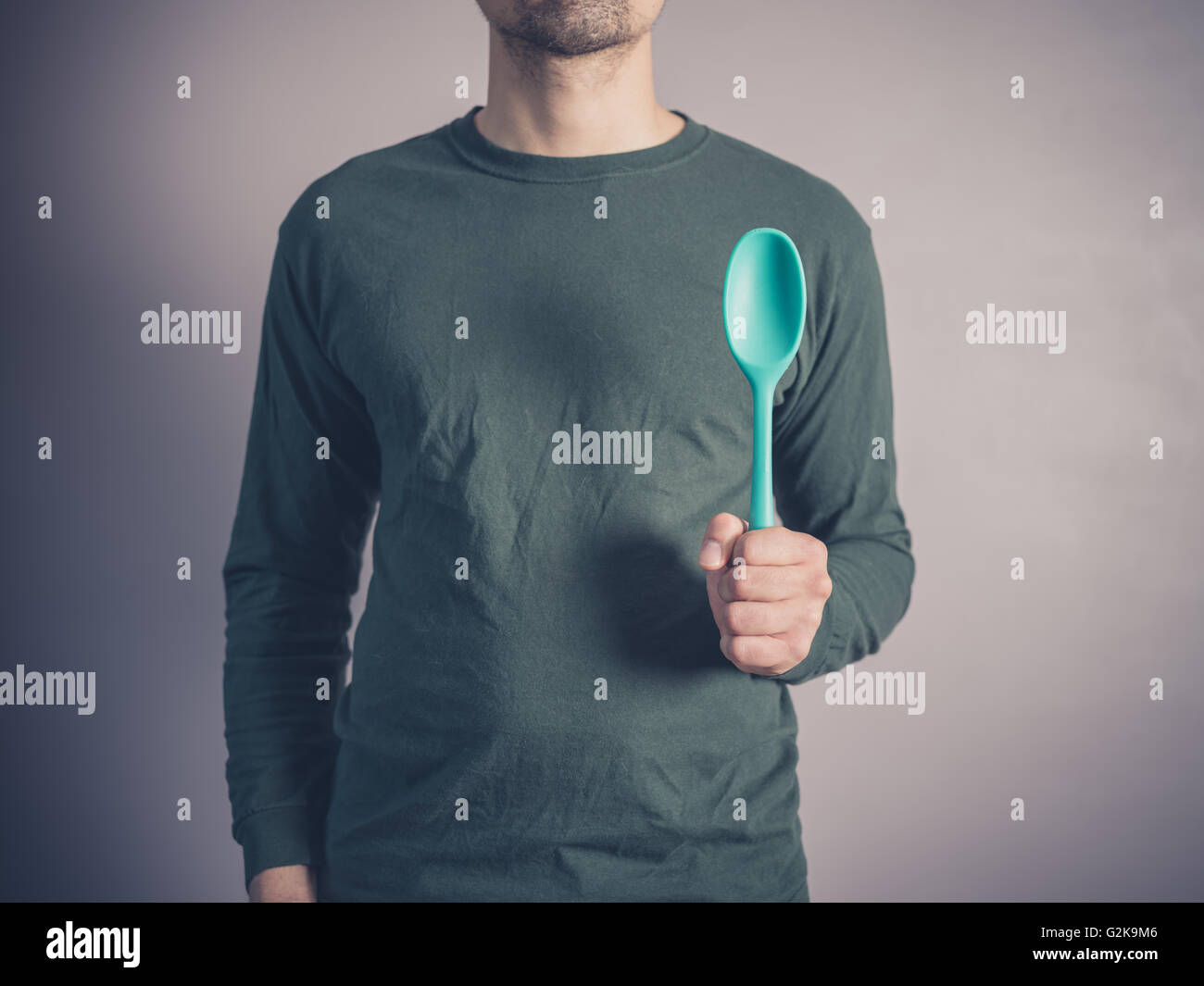 Man holding a spoon hi-res stock photography and images - Alamy