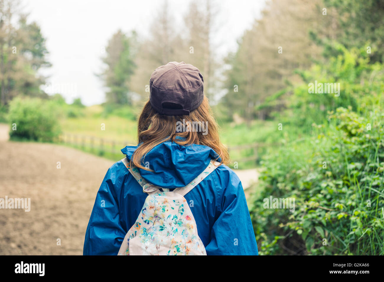 A young woman is walking alone in the forest Stock Photo - Alamy
