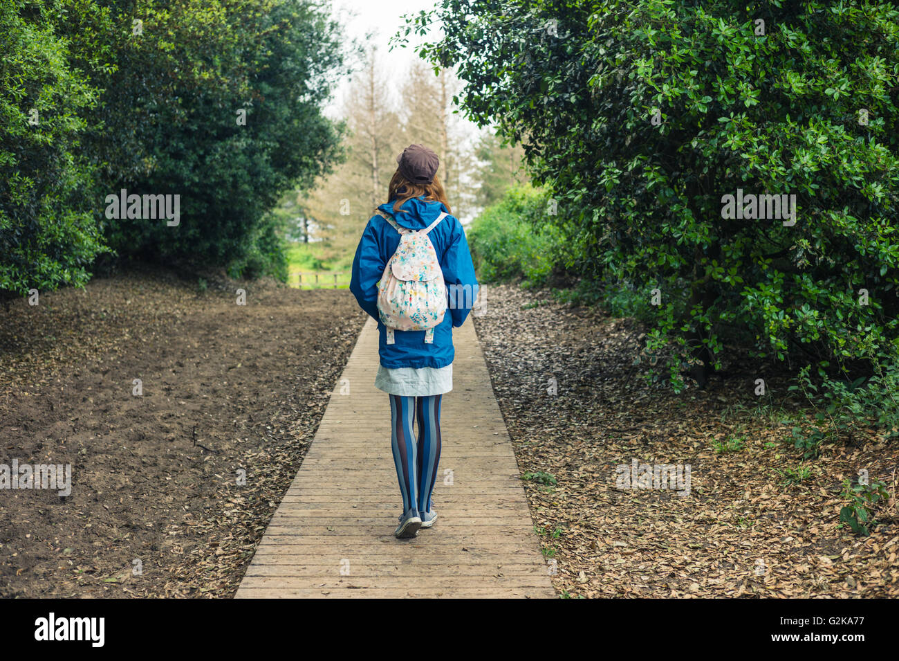 A young woman is walking alone in the forest Stock Photo - Alamy