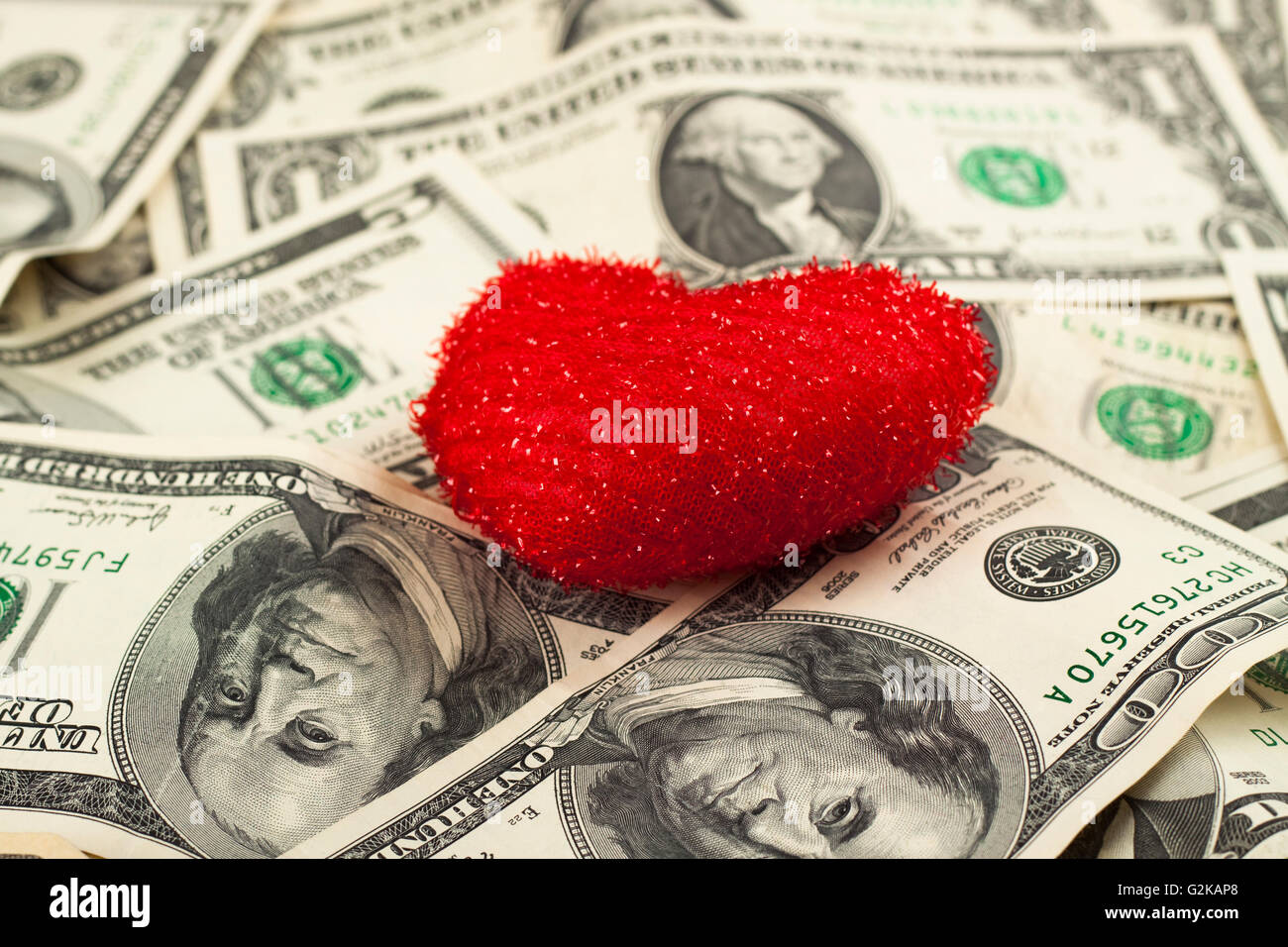 small red toy heart with dollar bills Stock Photo - Alamy