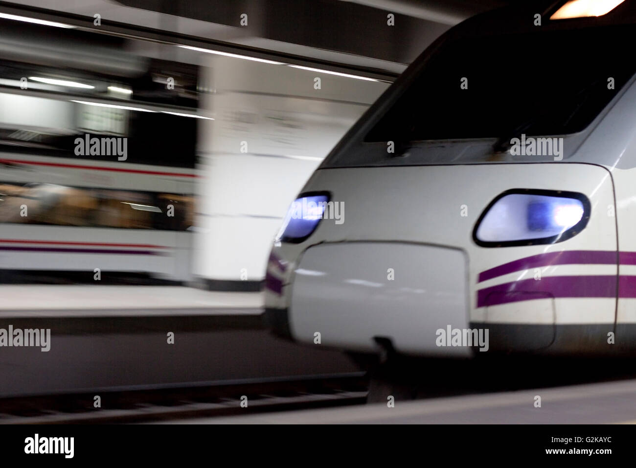 moving white train at night arriving the station Stock Photo - Alamy