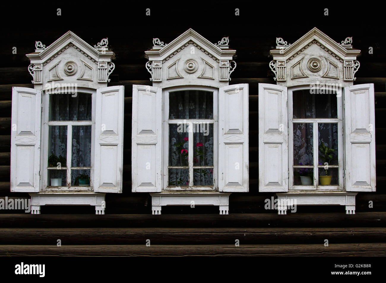Three Windows with White Shutters and Ornate Wood Detail Stock Photo ...