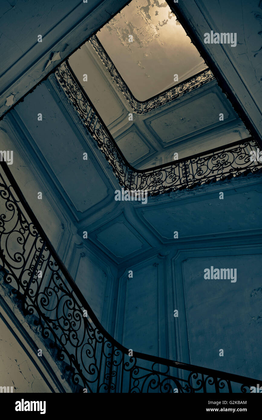 Spiraling Staircase with Ornate Railing in Rundown Building, Low Angle ...