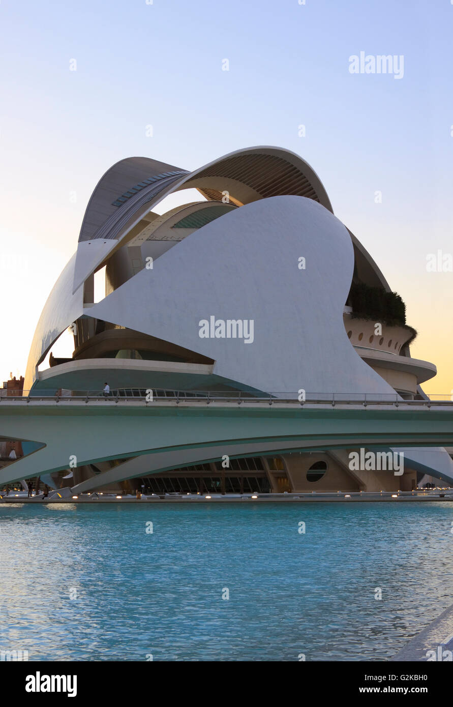 big white fish like looking building sorunded by water on sunset sky ...