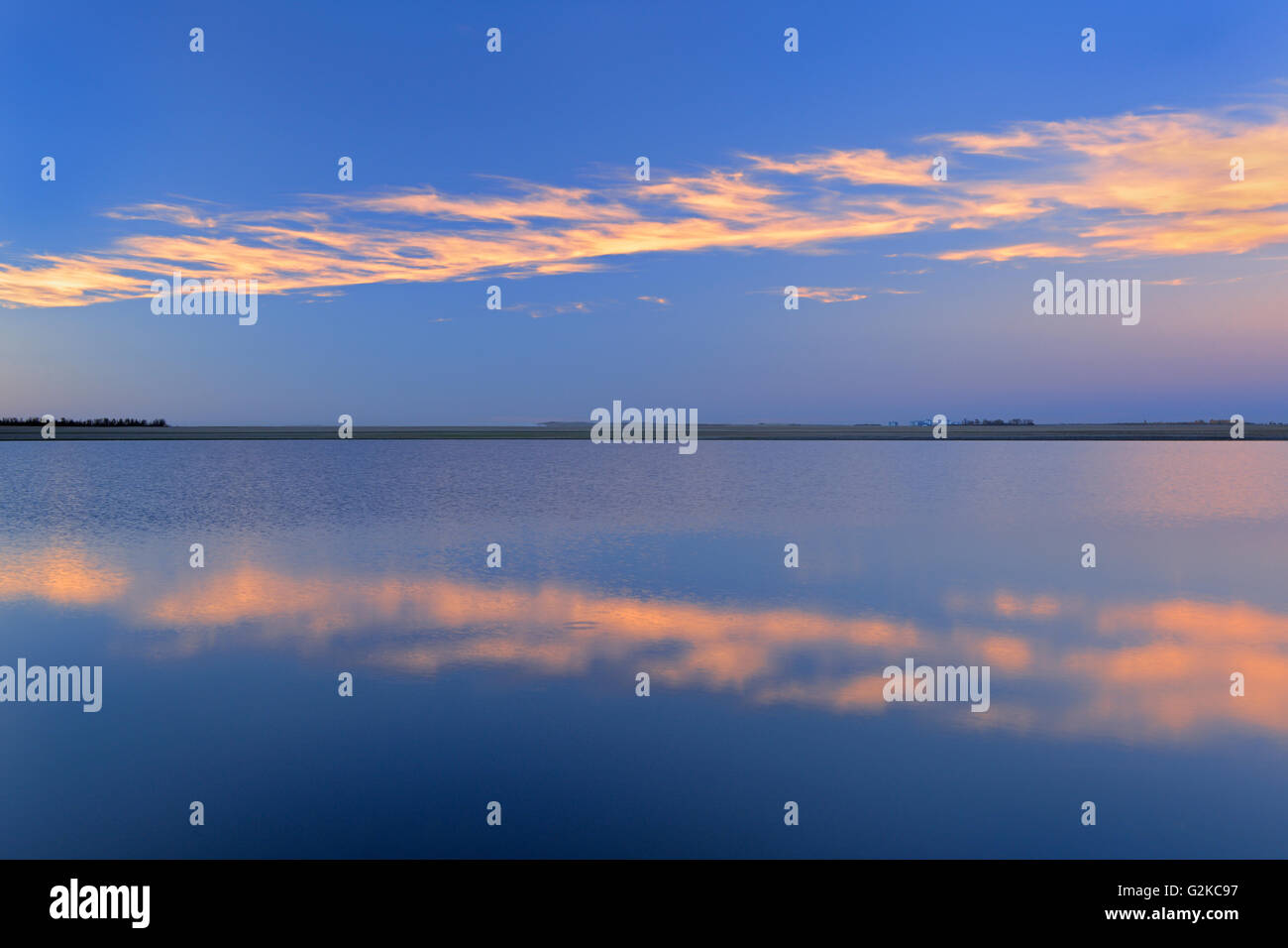 Clouds reflected in wetland at sunset Tuxford Saskatchewan Canada Stock ...