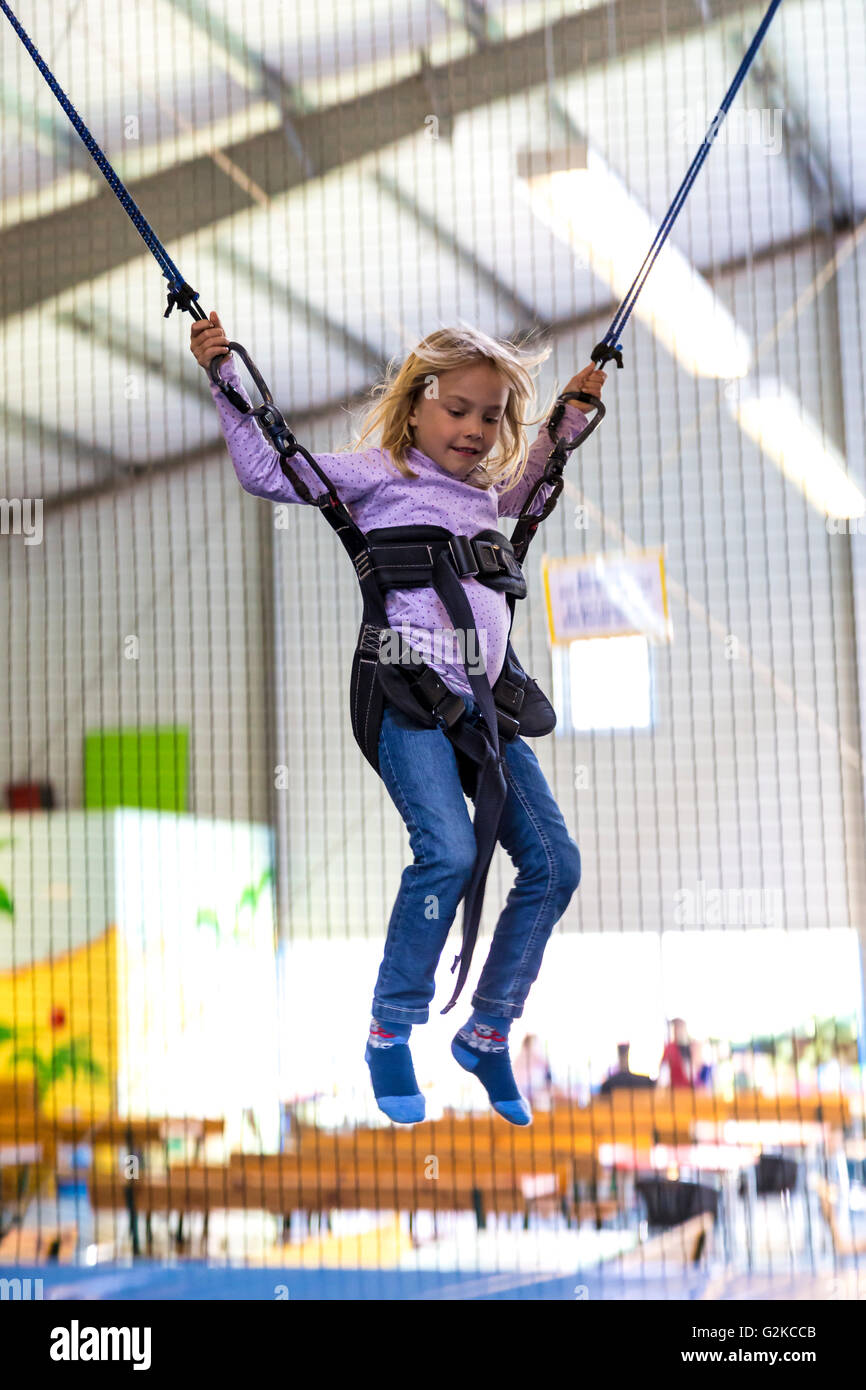 Lttle girl running hopping with ropes in an indoor playground Stock ...