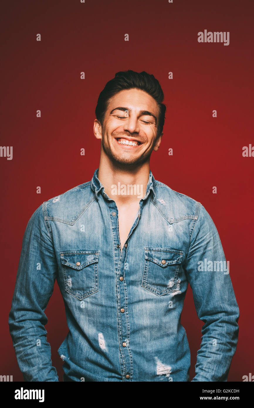 Portrait of smiling young man with closed eyes Stock Photo - Alamy