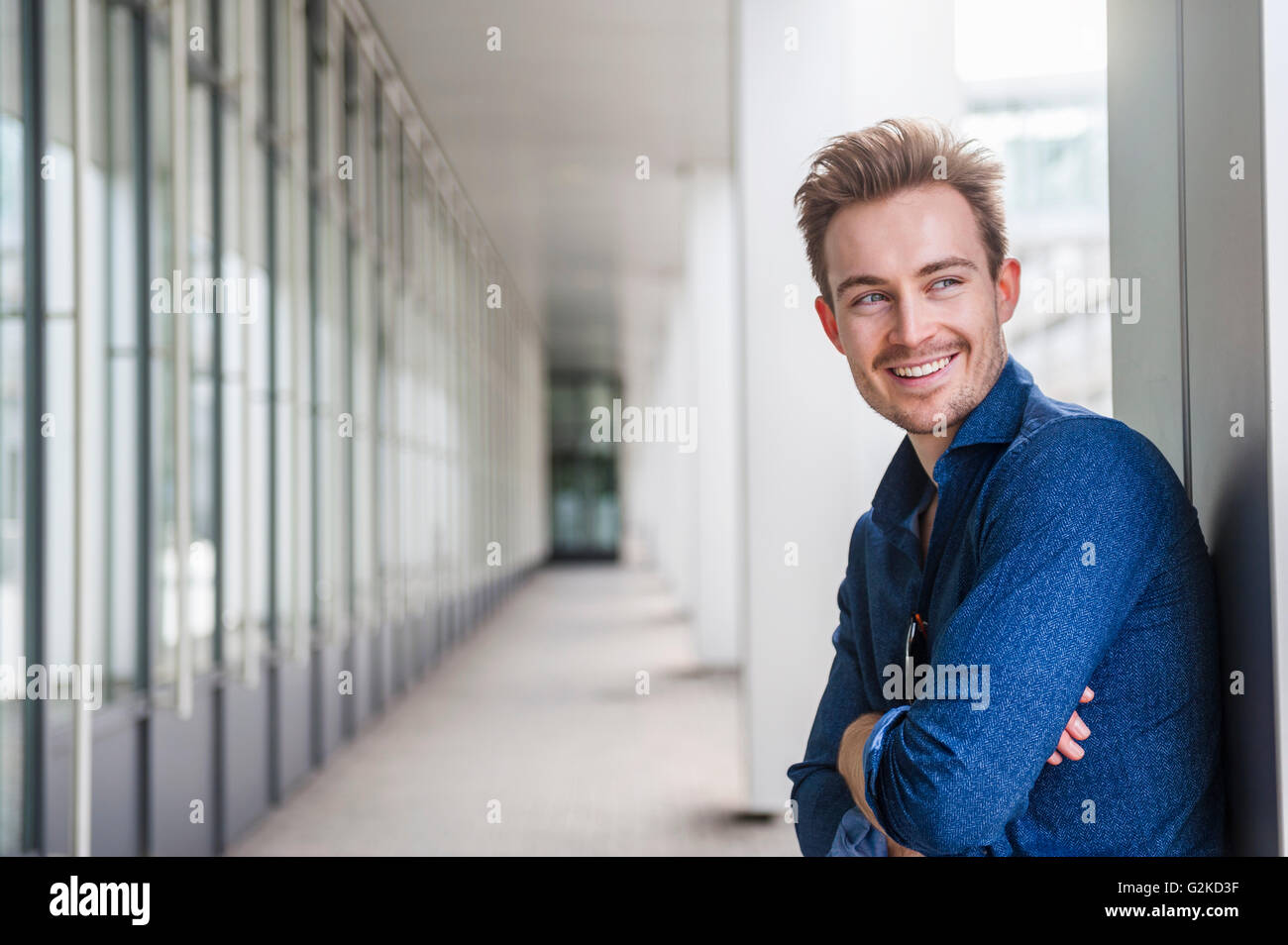Portrait of relaxed young businessman with crossed arms Stock Photo - Alamy