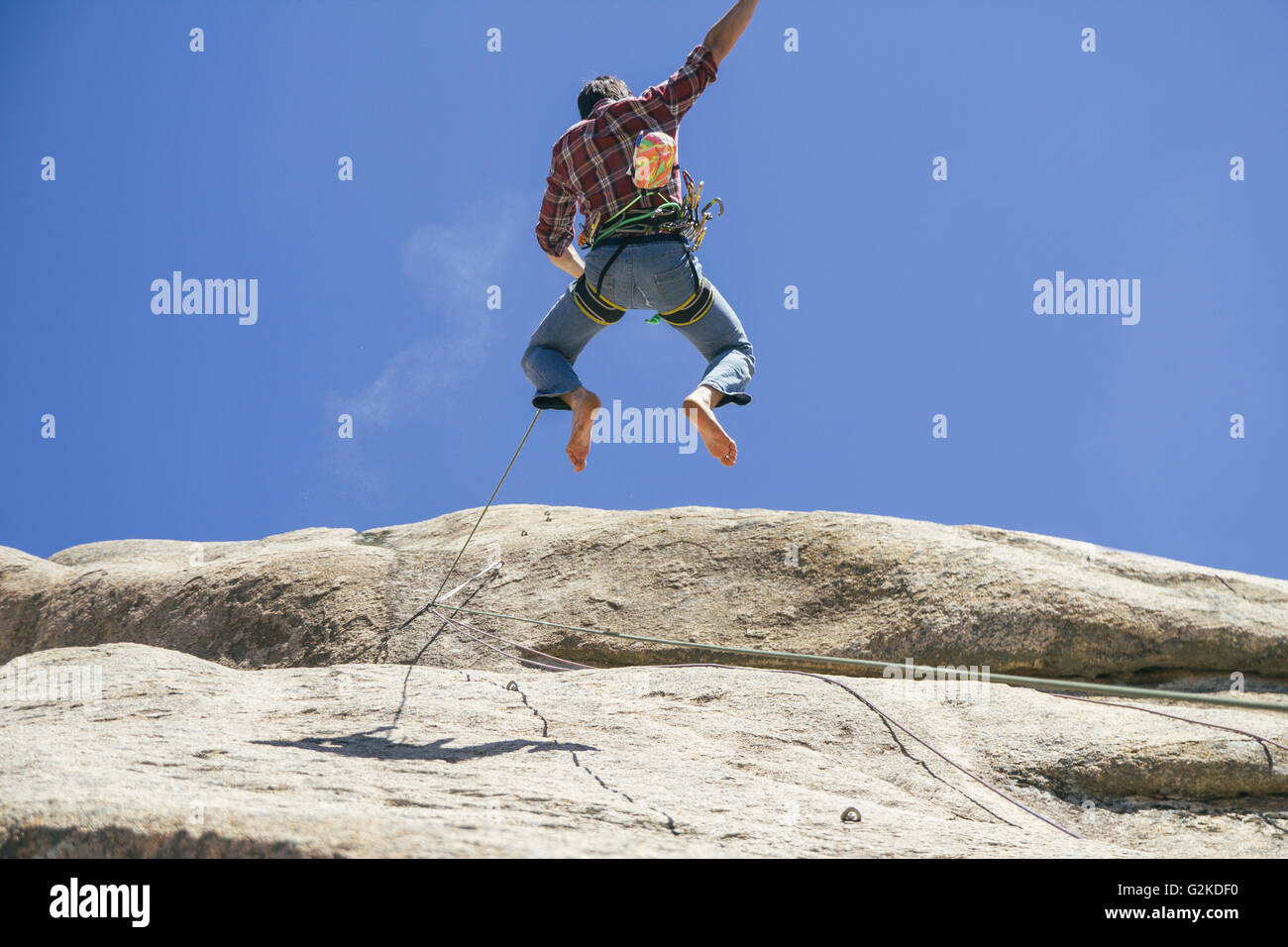 Climber jumping in a wall Stock Photo - Alamy