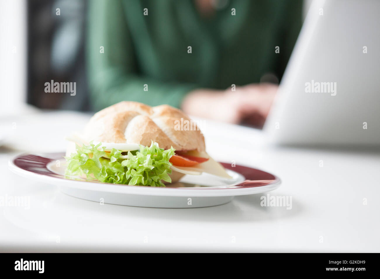 Garnished bread roll on office desk Stock Photo - Alamy