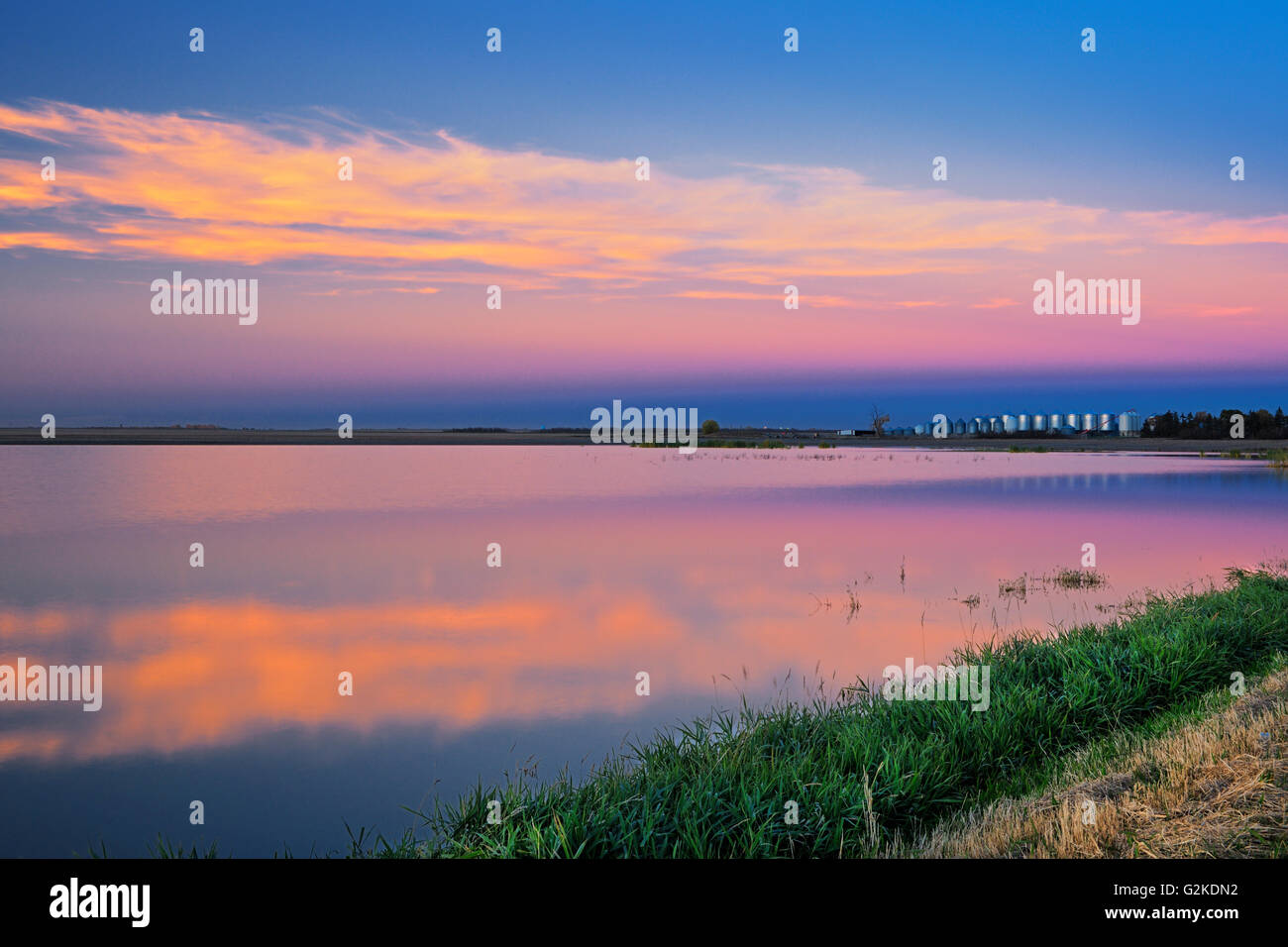 Sunset with grain bins and water Tuxford Saskatchewan Canada Stock ...