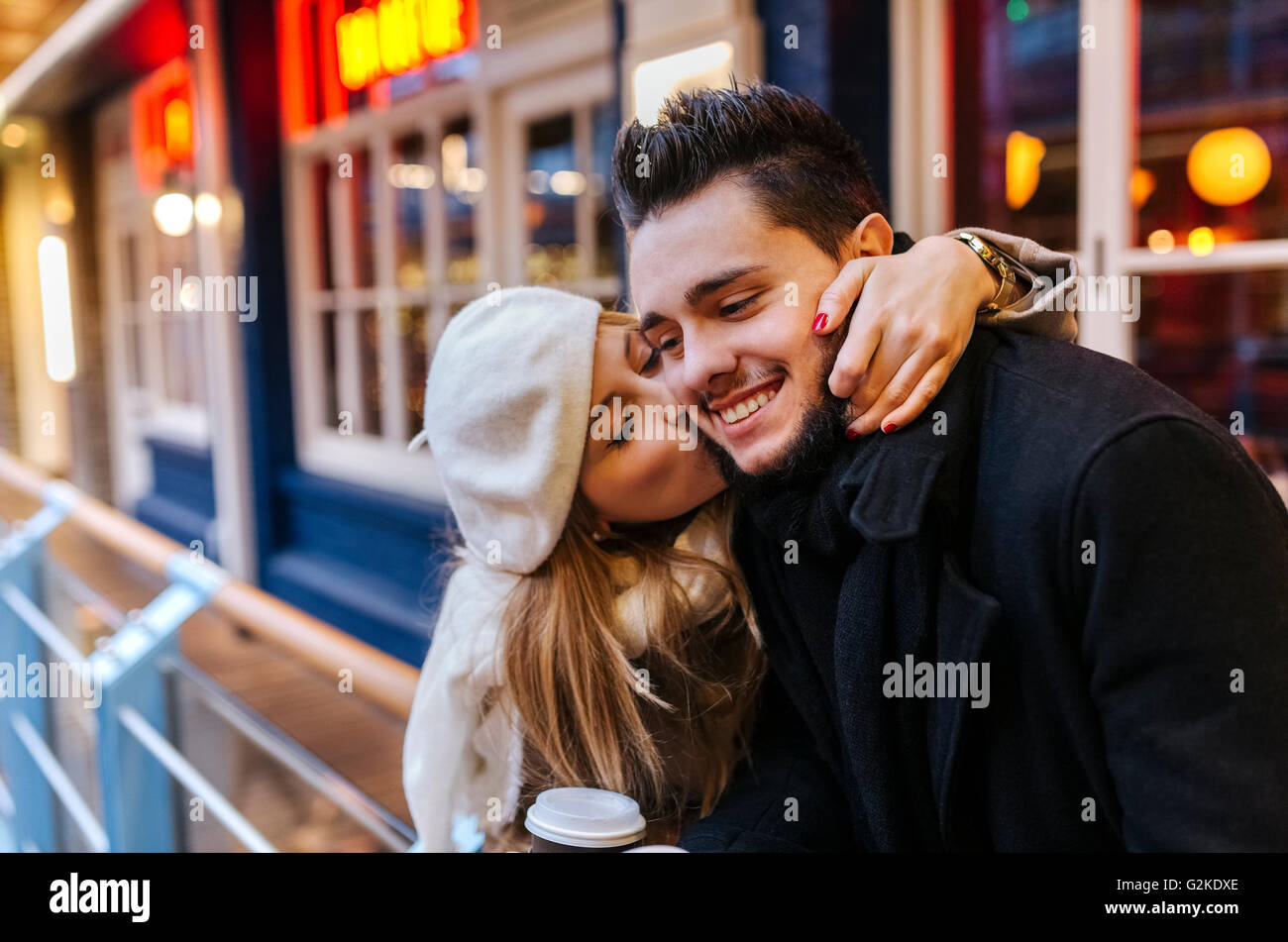 Young woman kissing her boyfriend Stock Photo - Alamy