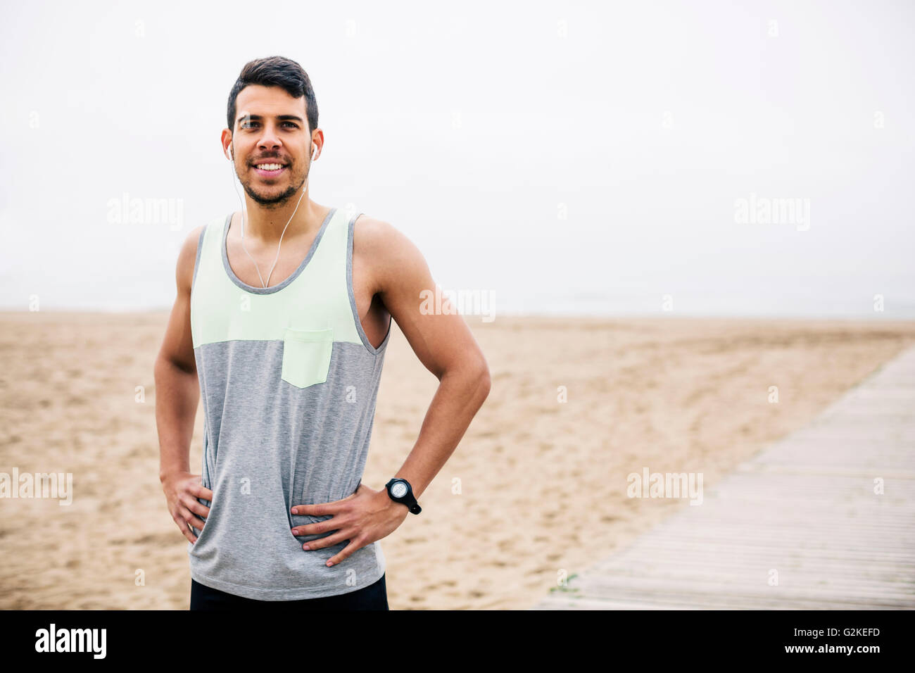 Portrait of smiling athlete on the beach Stock Photo - Alamy