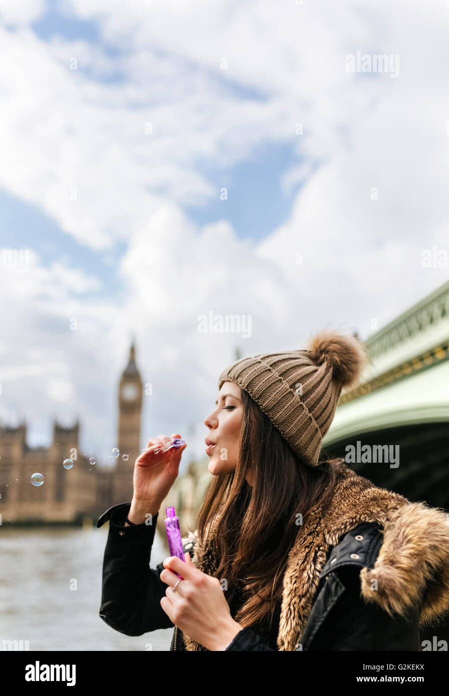 UK, London, young woman blowing soap bubbles Stock Photo - Alamy