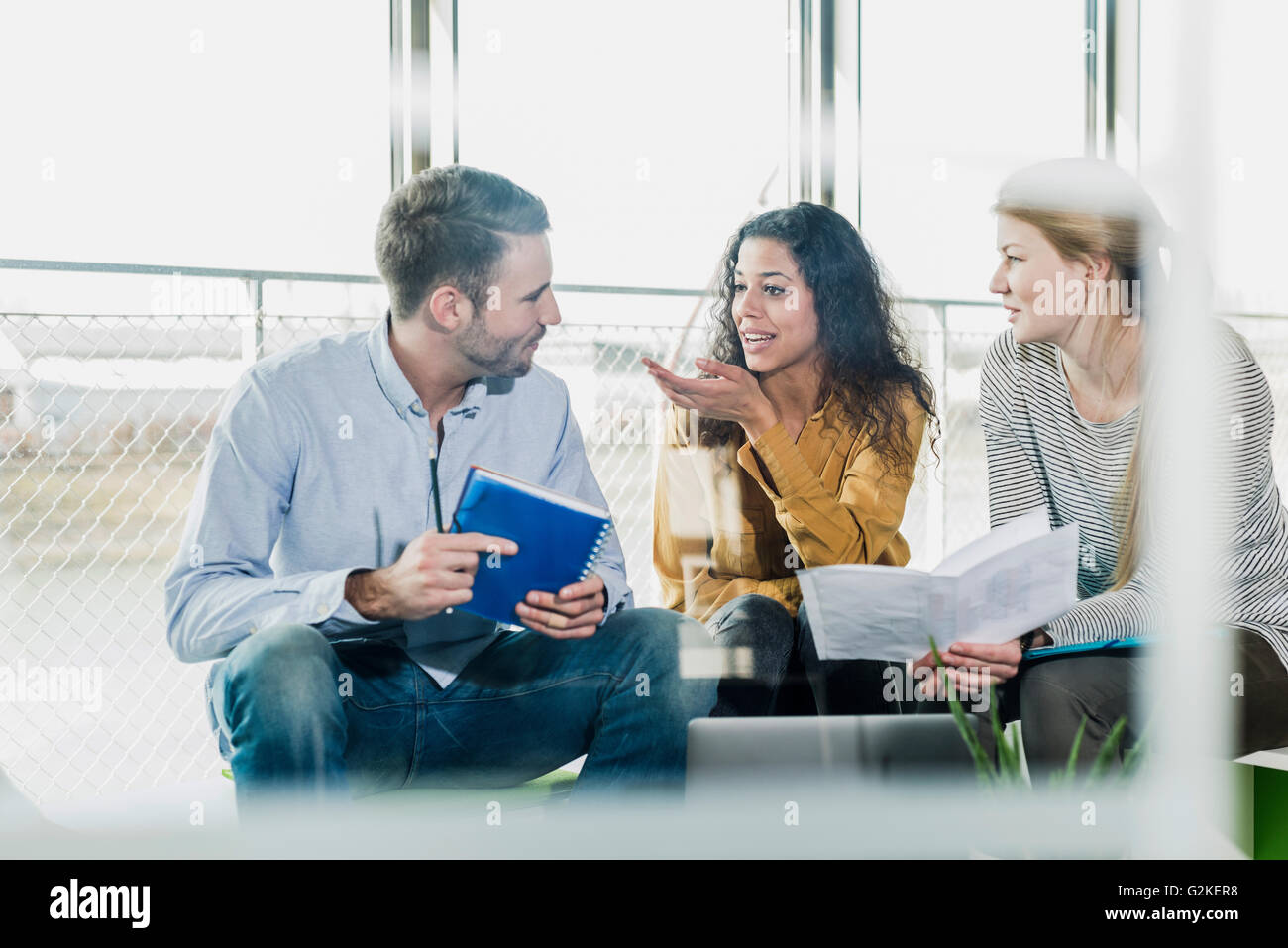 Three colleagues in office working together Stock Photo - Alamy
