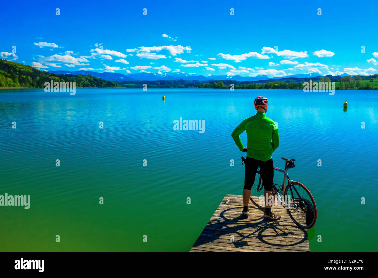 Germany, Rupertigau, Waginger See, man with bicycle standing on pier ...