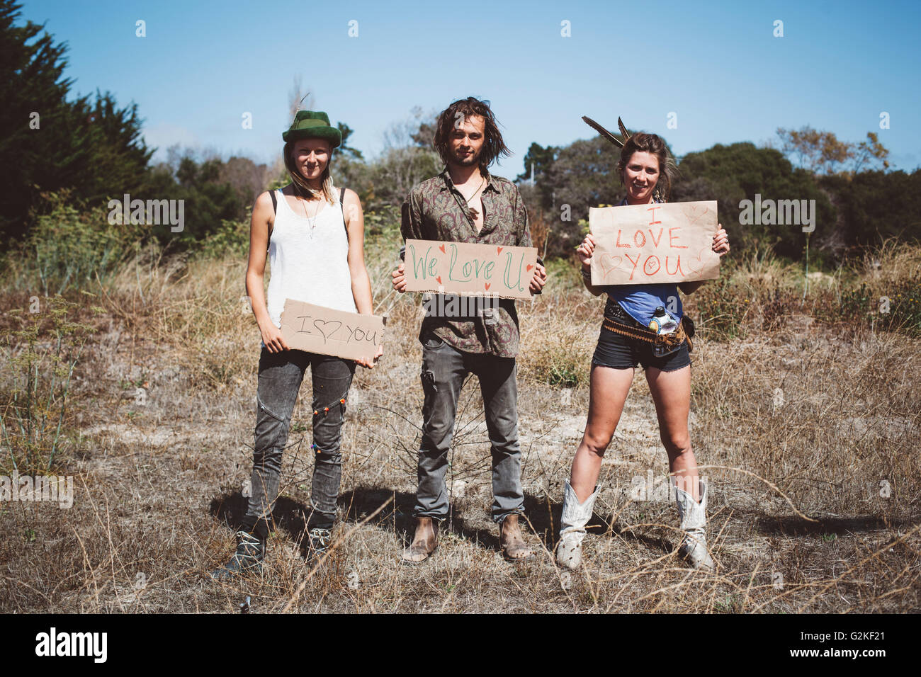 Three hippies holding 'I love you' signs in the nature Stock Photo - Alamy